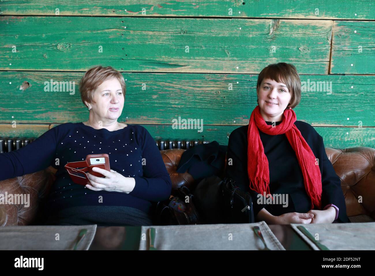 Portrait of two women at table in restaurant Stock Photo - Alamy