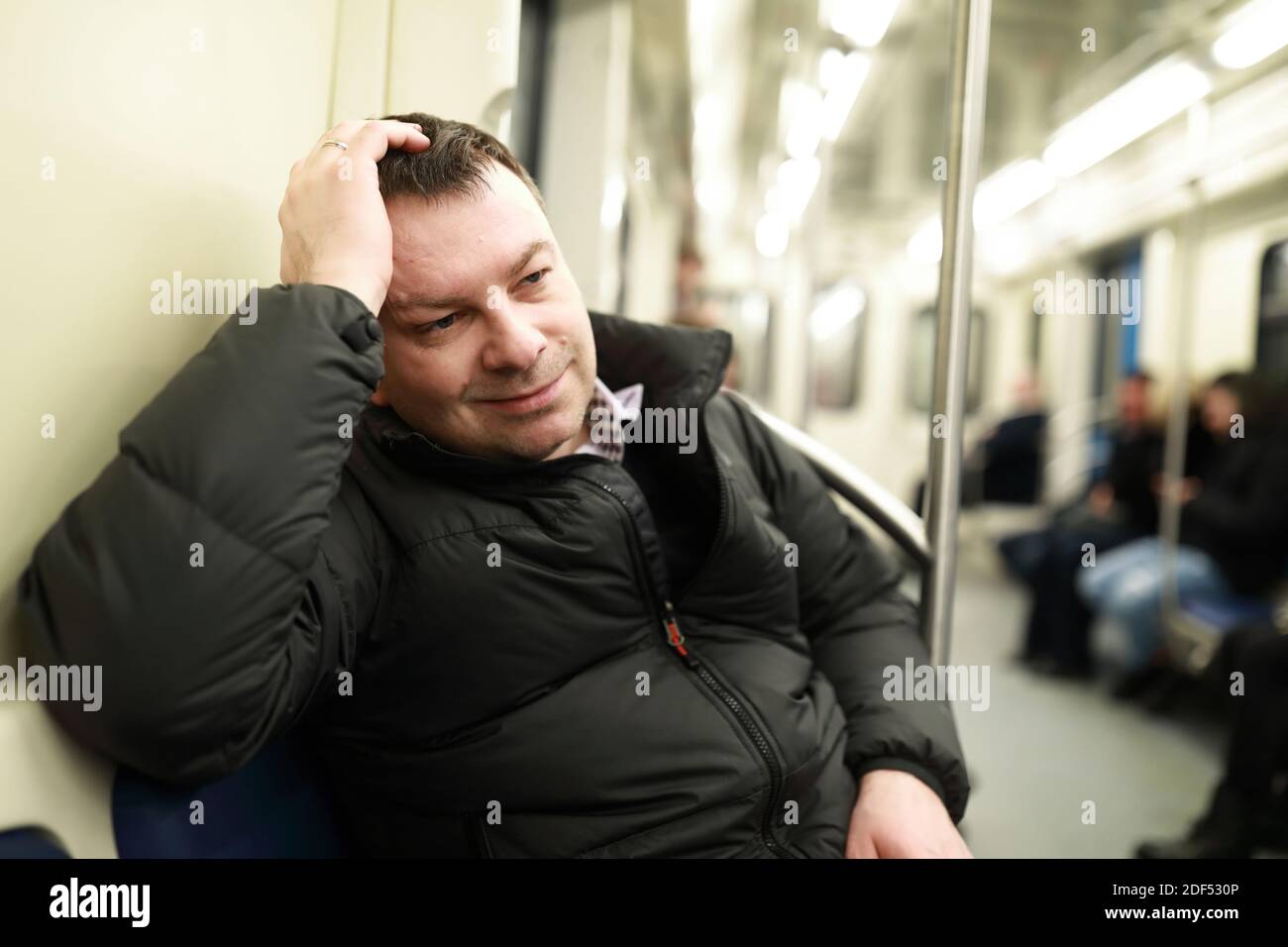 Portrait of smiling man in subway train Stock Photo - Alamy