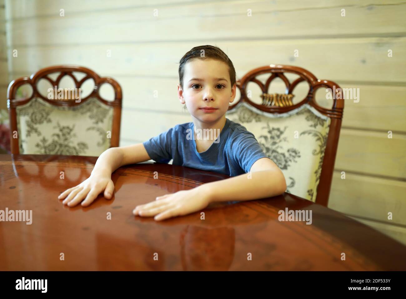 Child sitting at round table in restaurant Stock Photo - Alamy