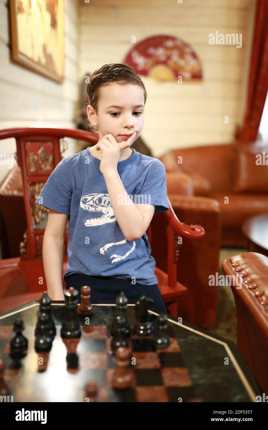 Child playing chess in chinese interior room Stock Photo - Alamy