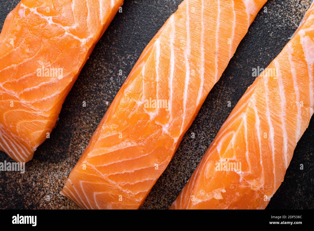 Raw salmon fillet, on old rustic background, top view Stock Photo - Alamy
