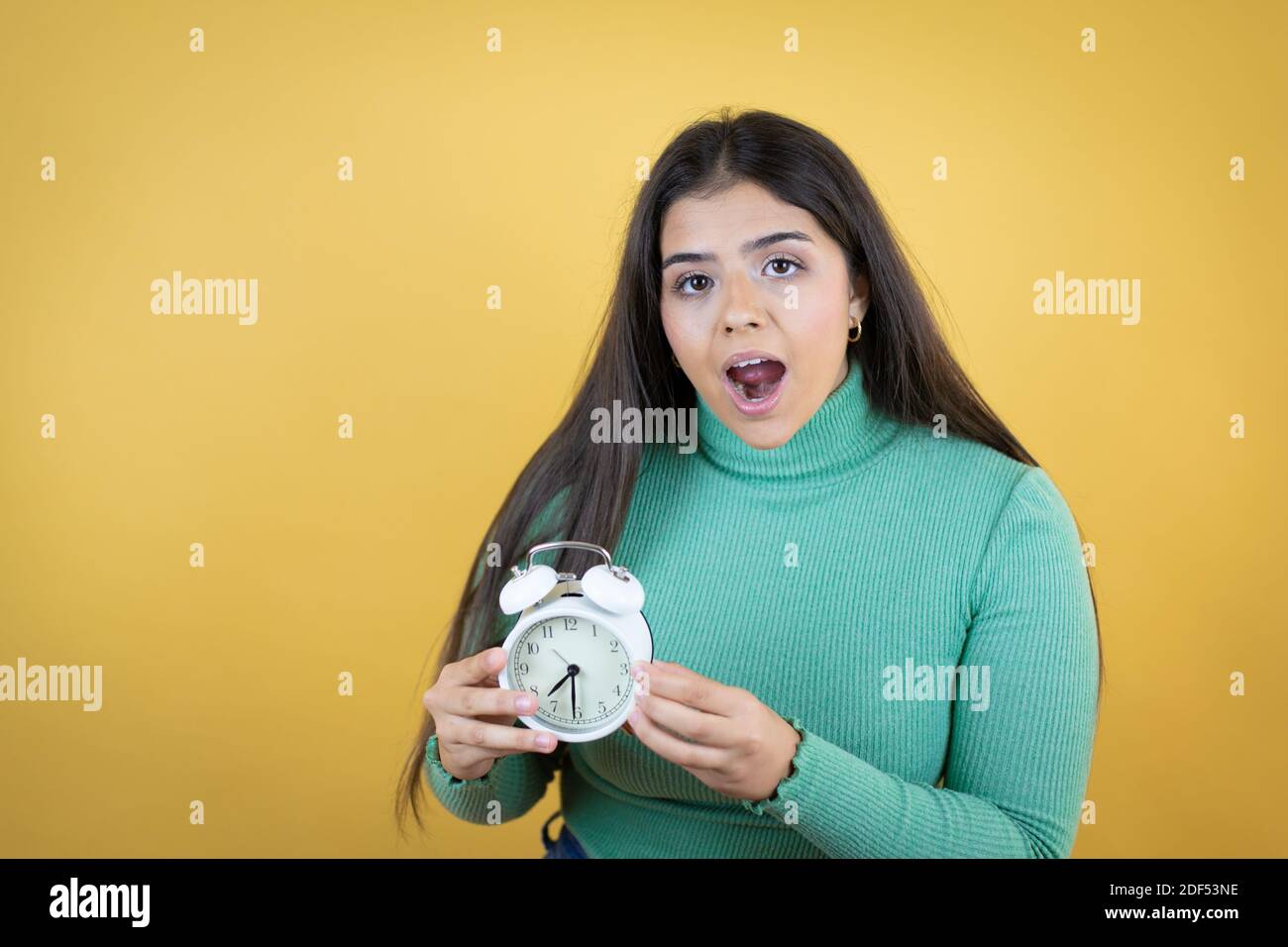 Young caucasian woman over isolated yellow background screaming and ...