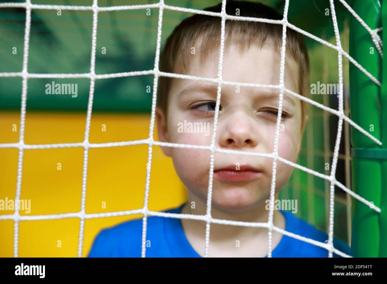Boy behind wire fence hi-res stock photography and images - Alamy
