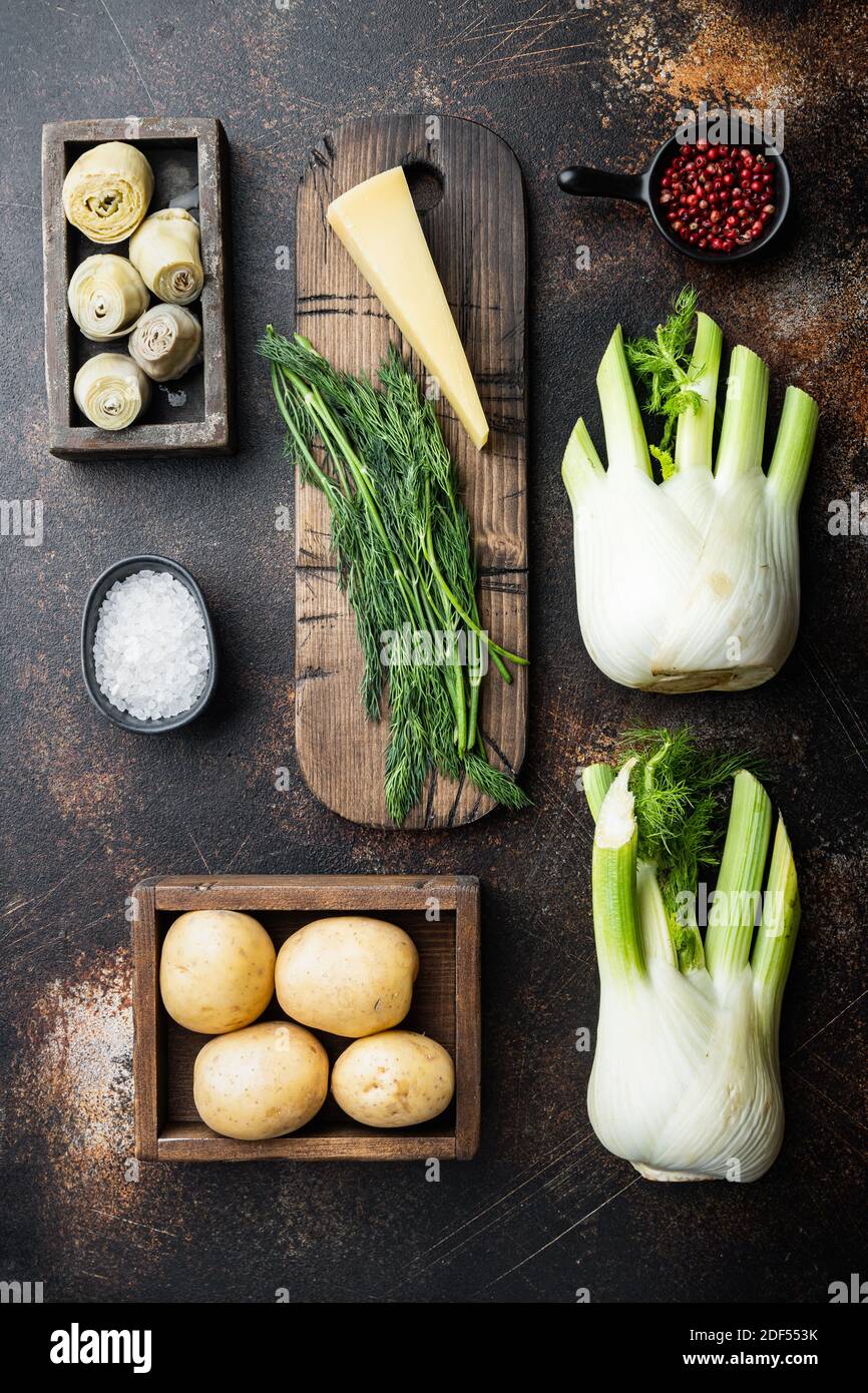 Potato and artichoke al forno ingredient, on old rustic background, top ...