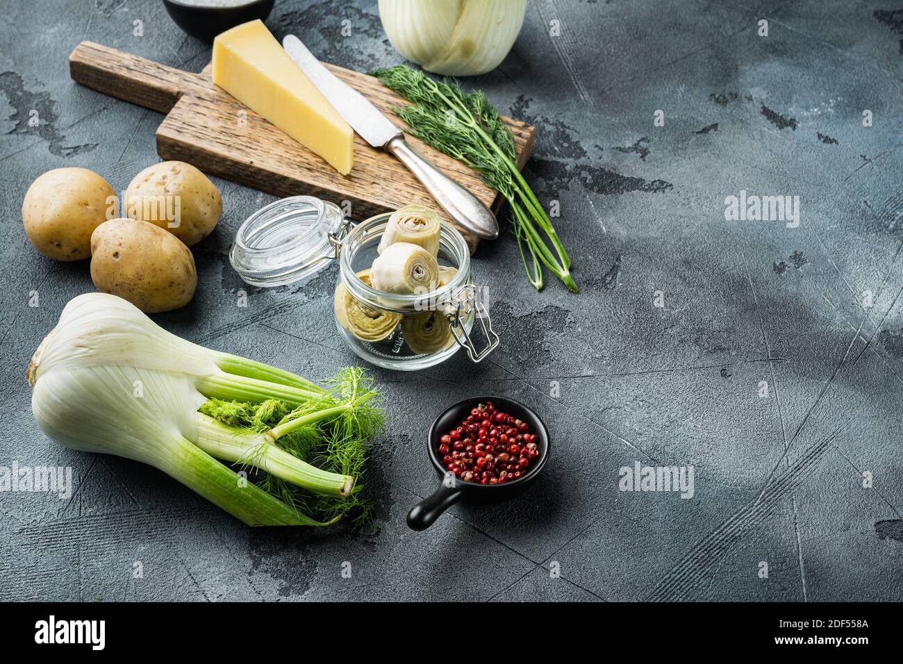 Potato and artichoke al forno ingredient, on grey background with space ...