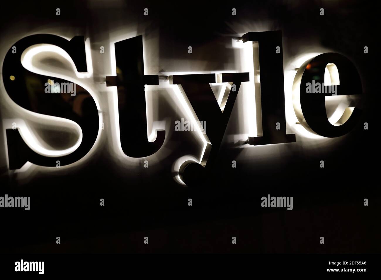 Details of style sign on wall at night Stock Photo - Alamy