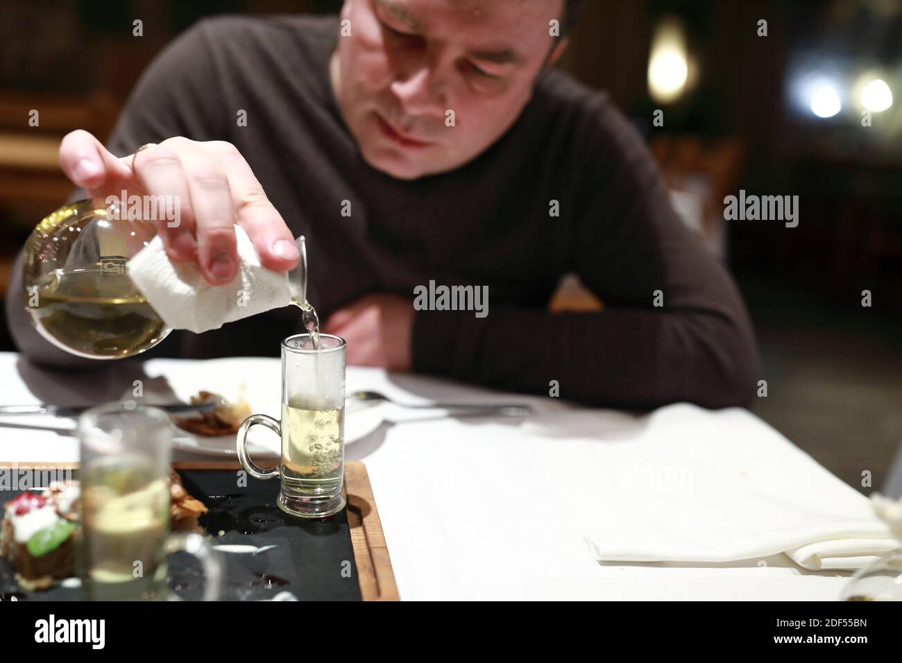 Man pouring green tea in a restaurant Stock Photo - Alamy