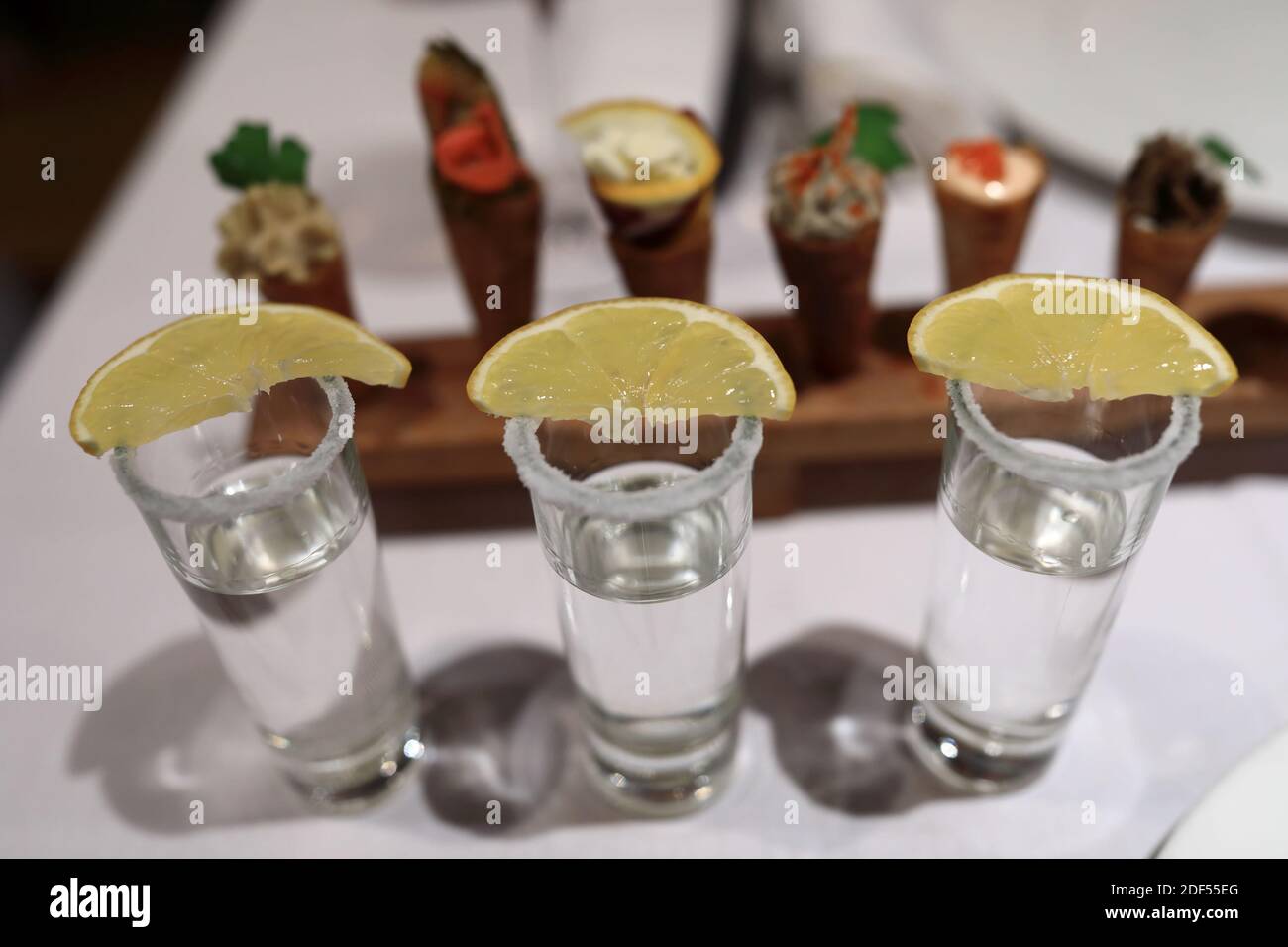 Three shots of tequila on table in restaurant Stock Photo - Alamy