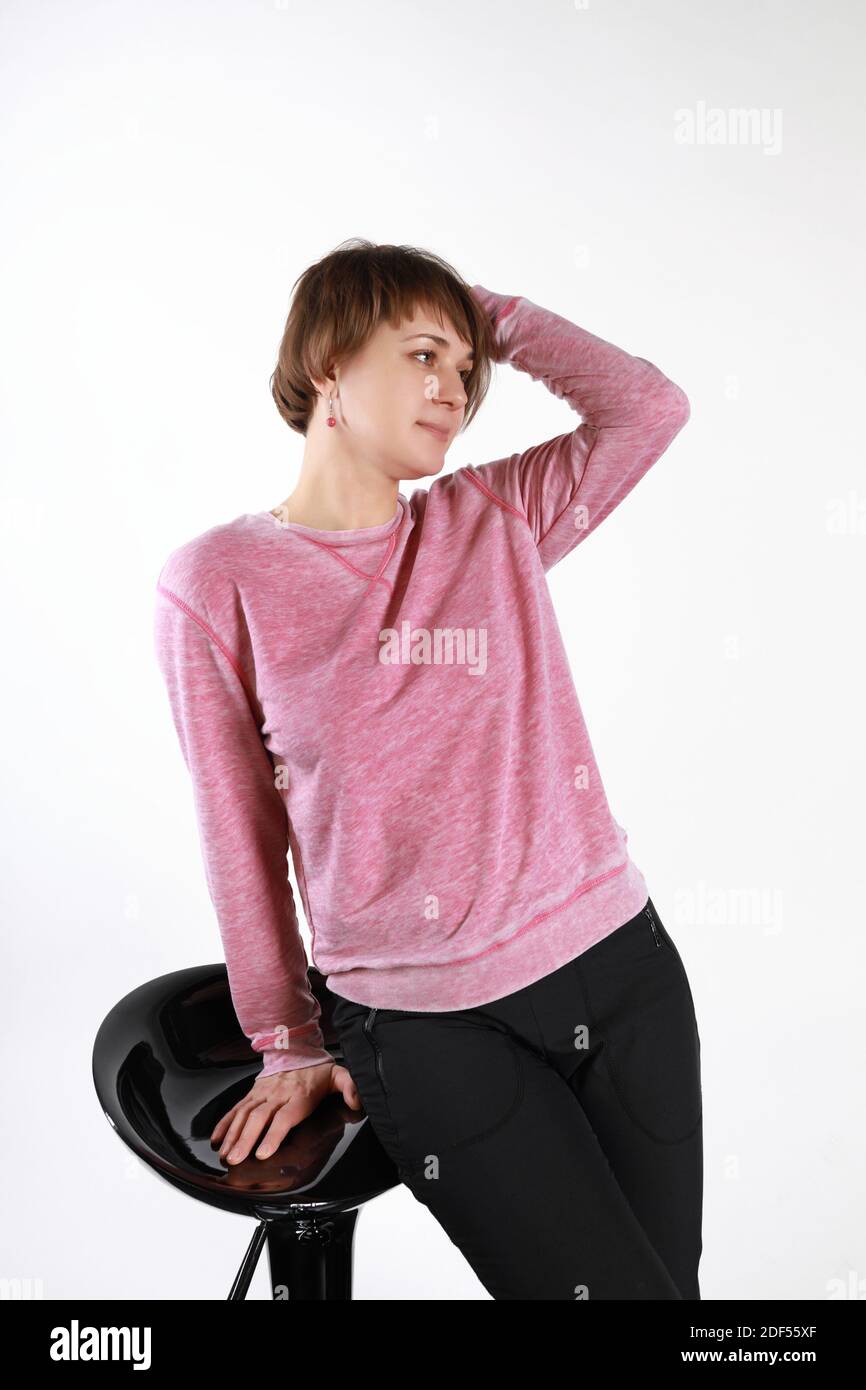 Woman with bar stool on white background Stock Photo - Alamy