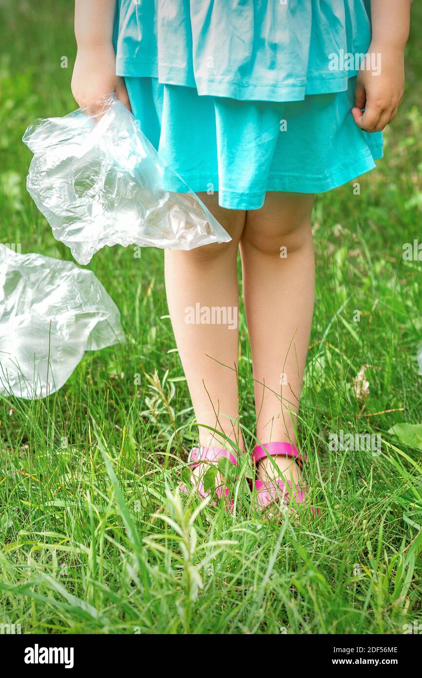 Used empty plastic bag in hands of a little girl while cleaning the ...