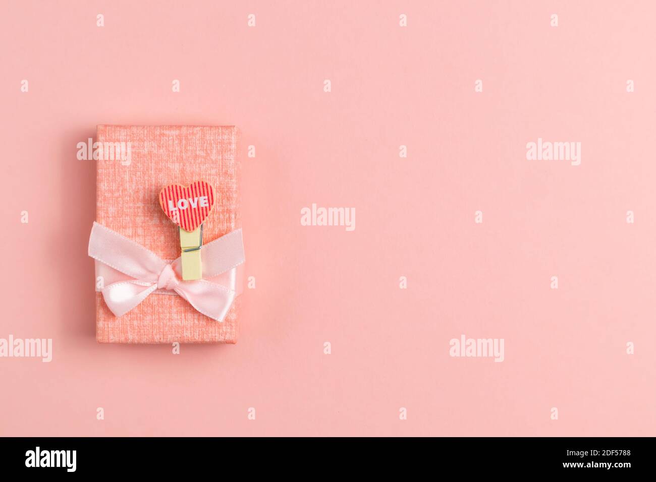 Pink box with a gift on a pink background with a place for text ...