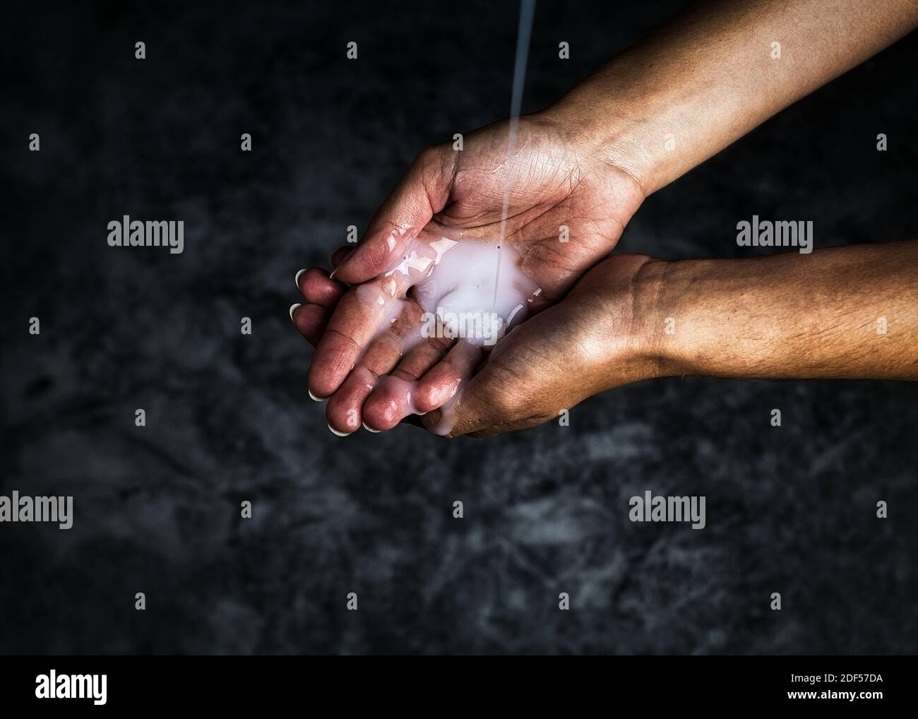 Soap pouring on woman's hand Stock Photo - Alamy