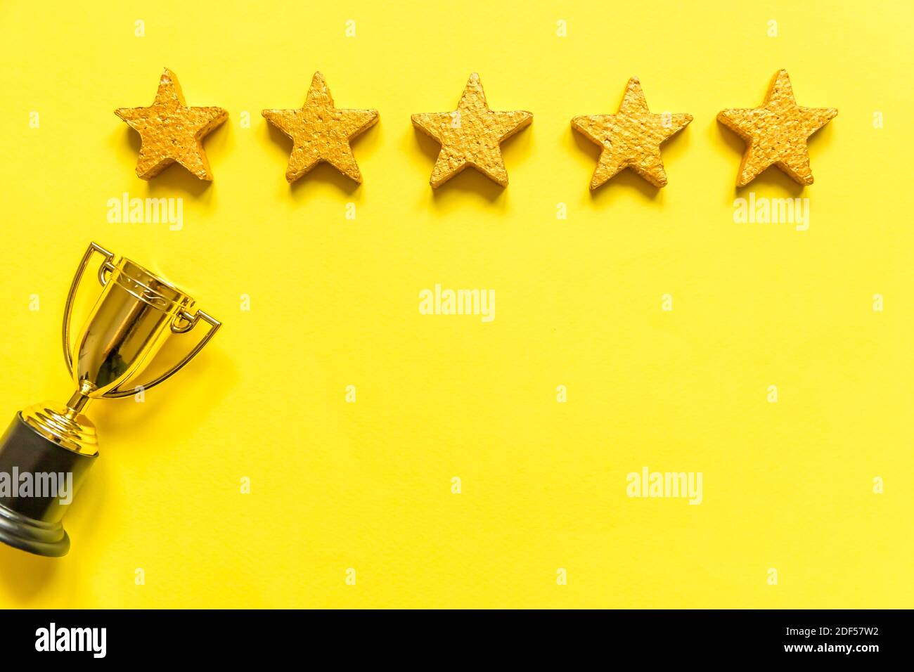 Simply flat lay design winner or champion gold trophy cup and 5 stars ...