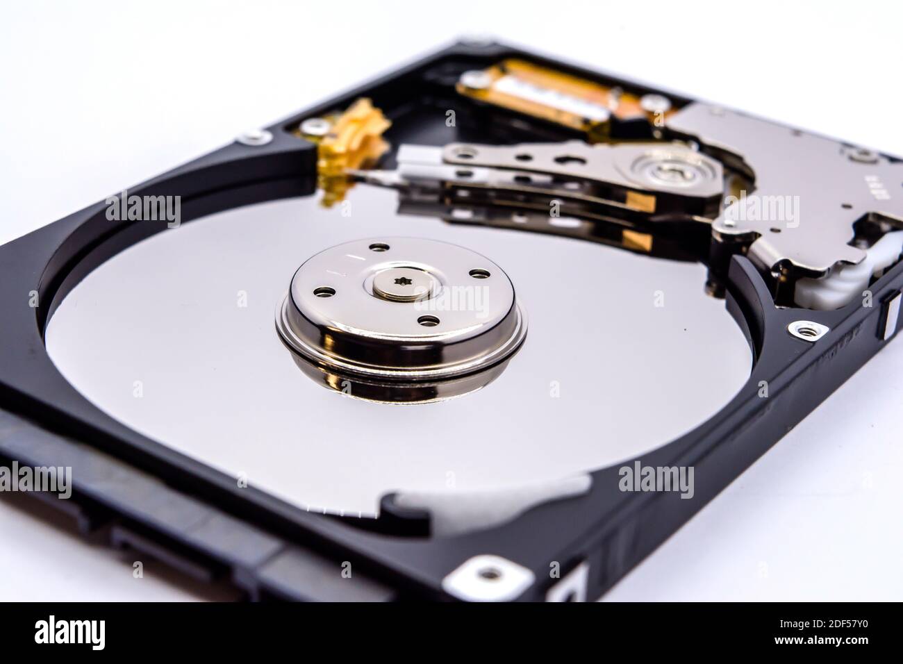 Internal parts of a hard disk isolated on a white background. Close up ...
