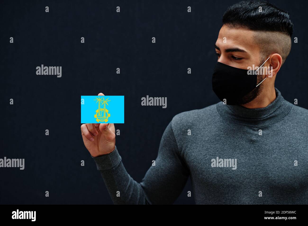 Egyptian man in gray turtleneck and black face protect mask show Aswan ...