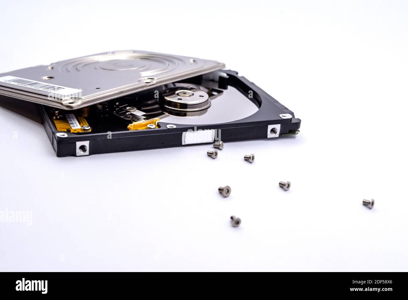 Internal parts of a hard disk isolated on a white background. Close up ...