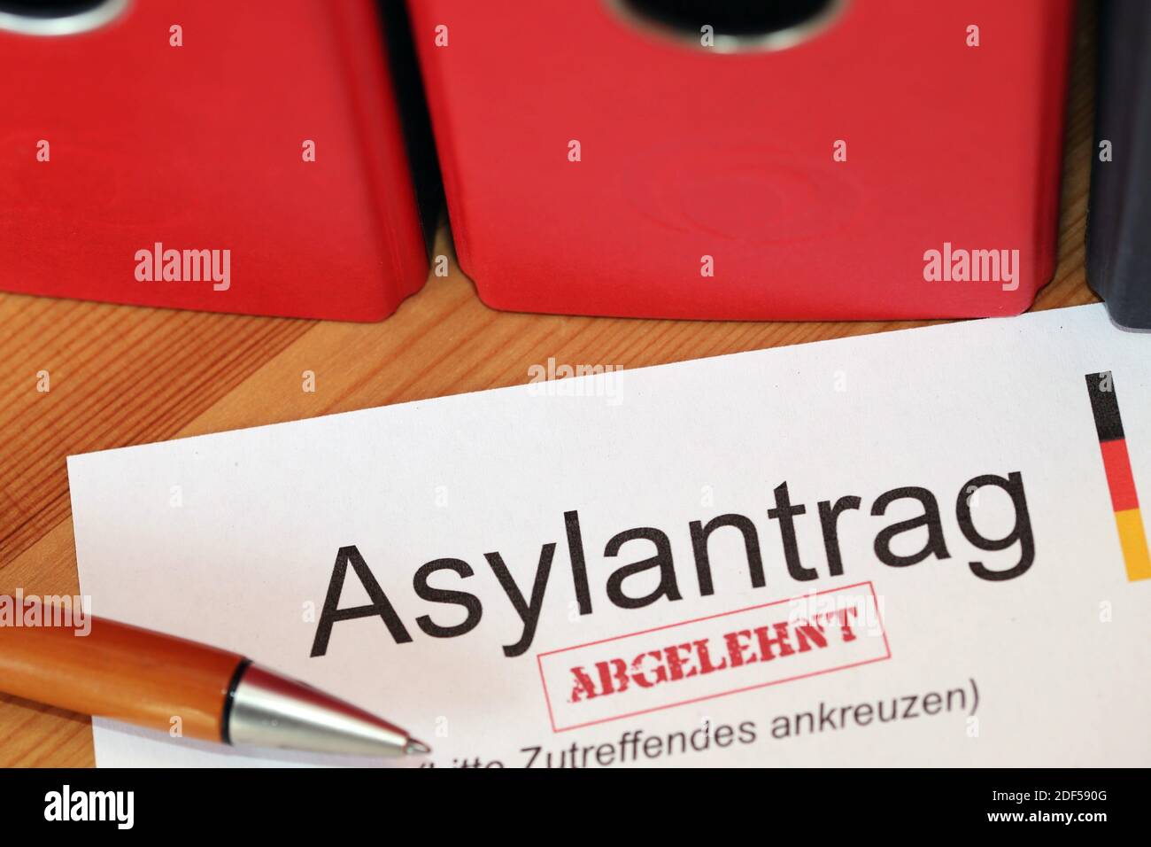 Symbol image: Application form for asylum with rejected stamp in ...
