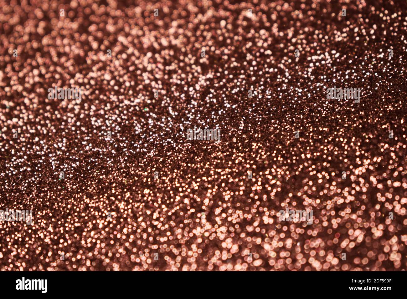 Bronze glitter, blurred effect. Glowing holiday light circles are ...