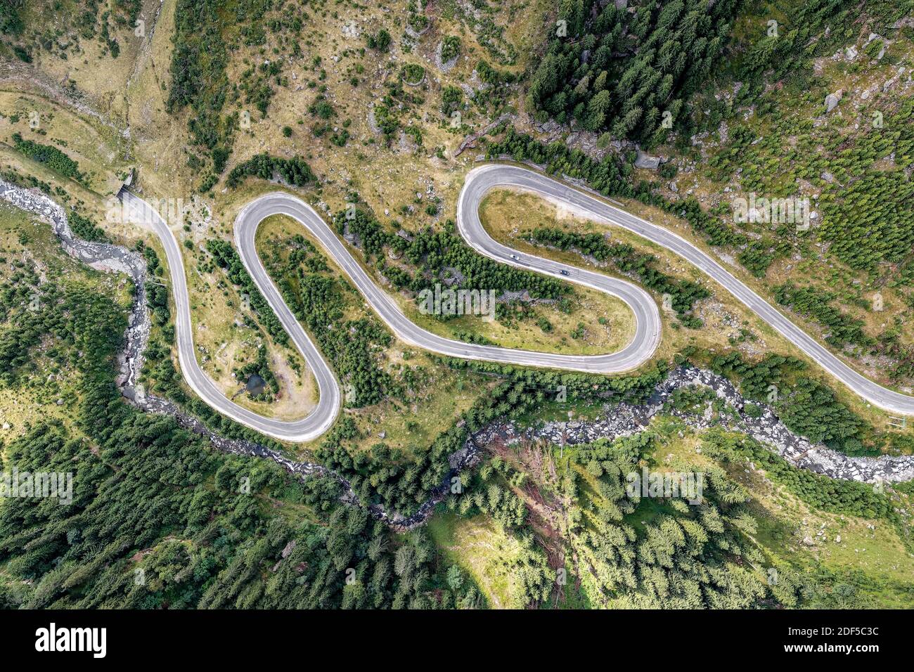 Winding road with a lot of turns, top view. Mountain river nearby. High ...