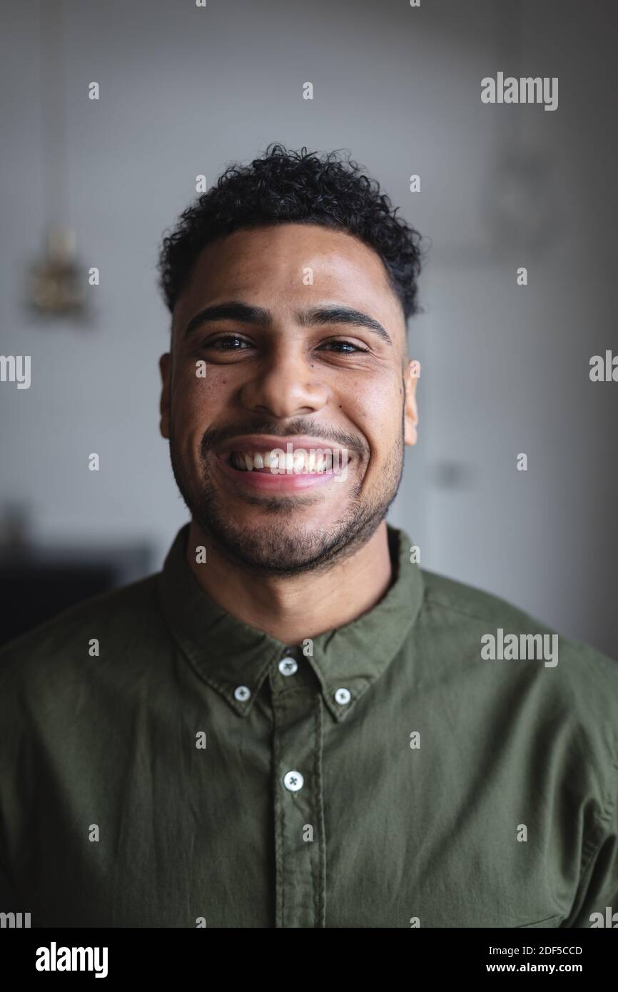 Portrait of middle eastern man smiling against grey background Stock ...