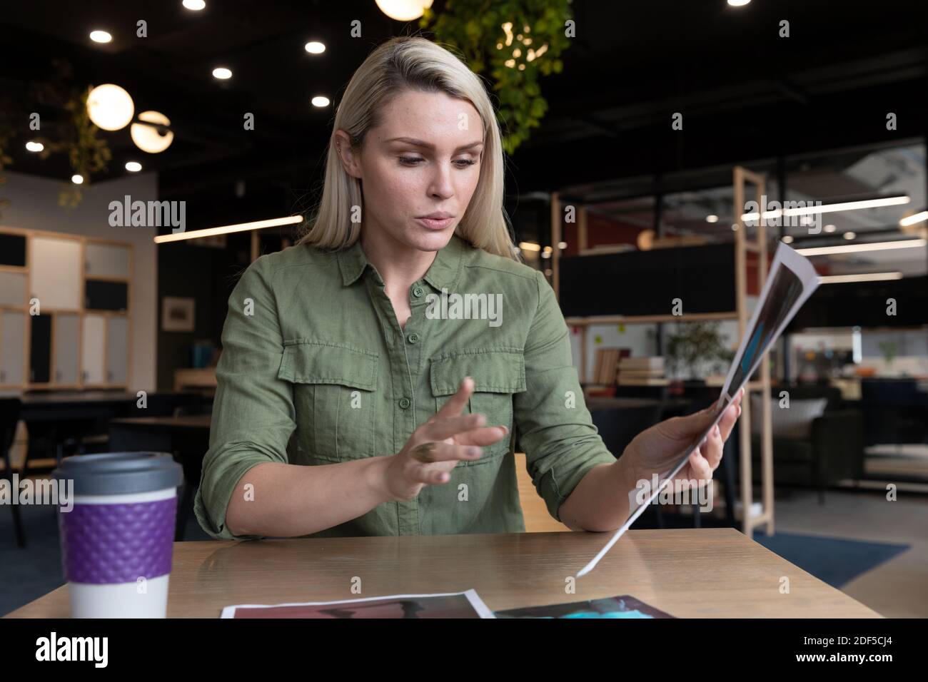 Caucasian businesswoman during video call in creative office, holding ...