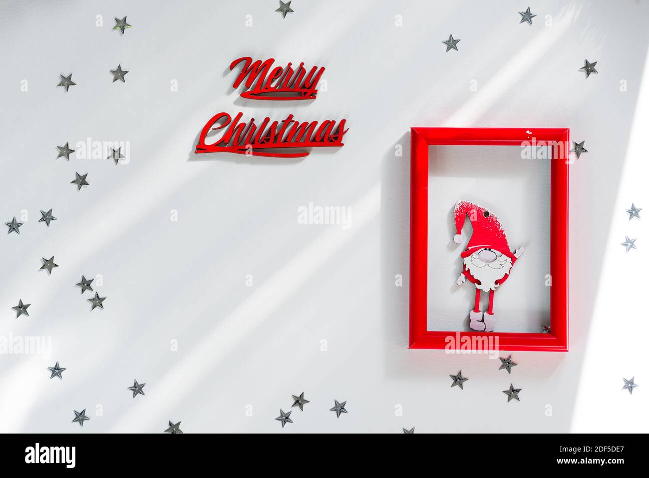 Funny handmade red gnom on frame with silver stars and letter Merry ...