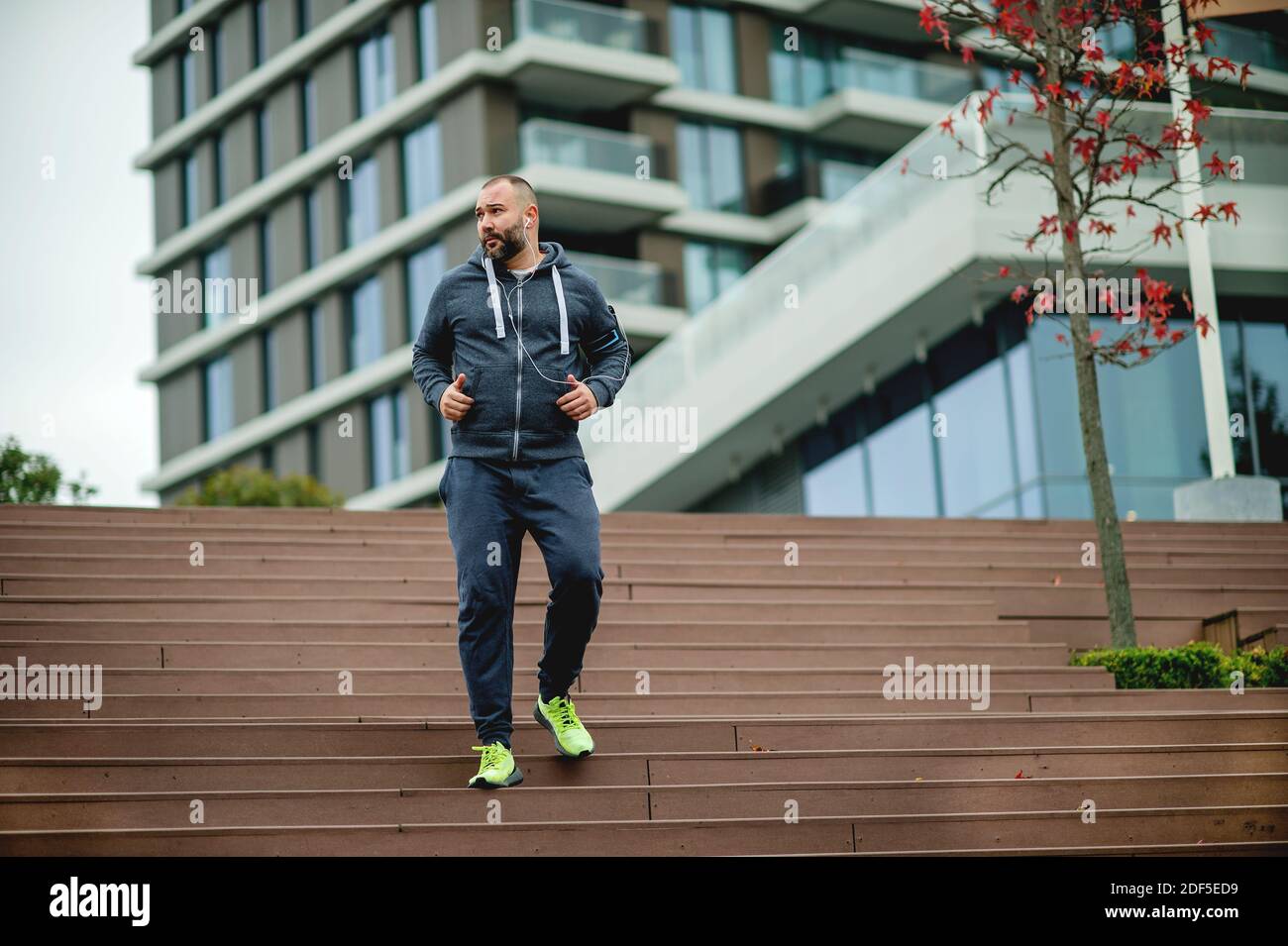 Young man jogging on stairs Stock Photo - Alamy