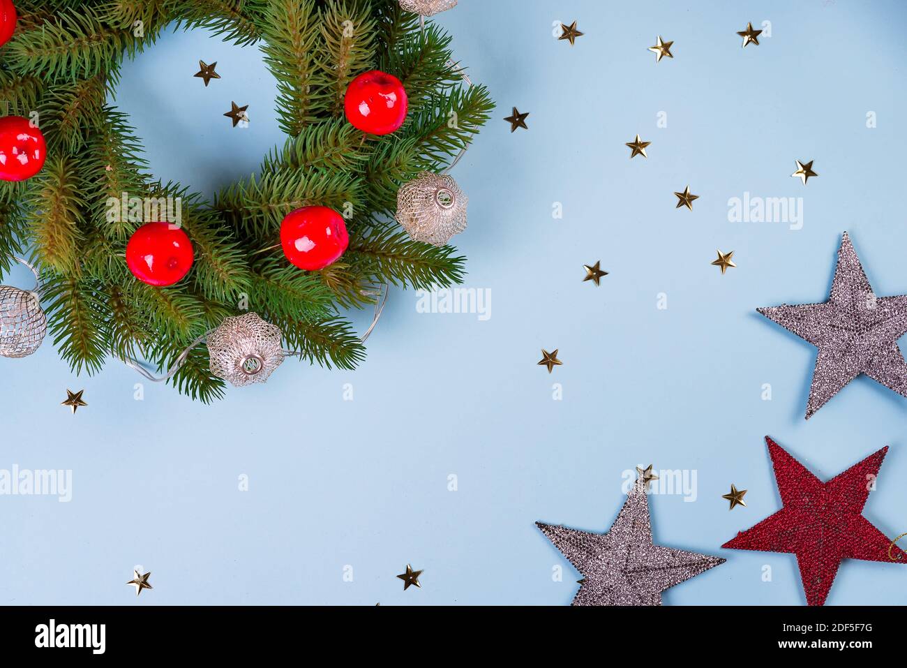 Rustic Christmas wreath with decorations and big stars toys on a blue ...