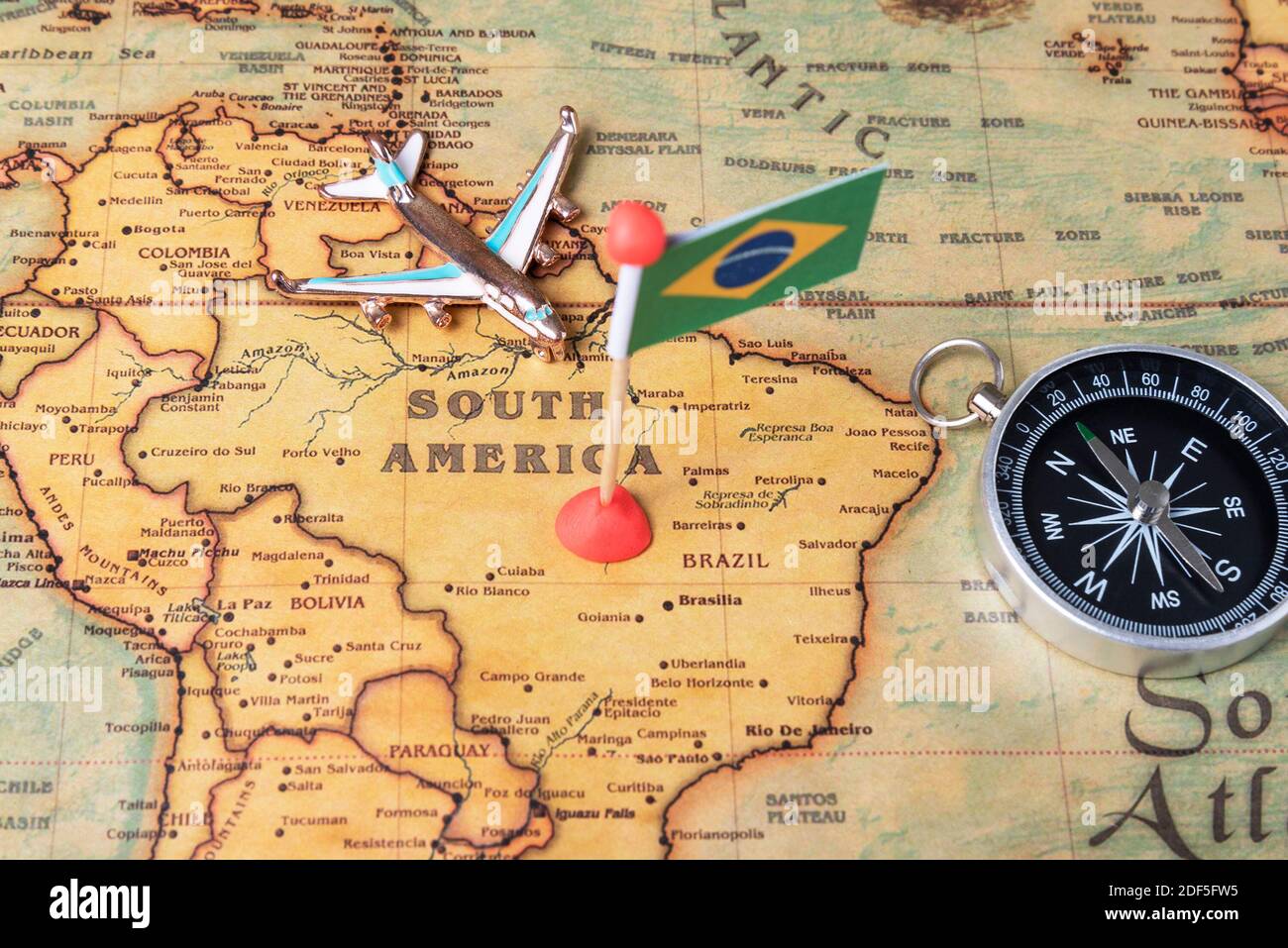 Flag of Brazil, compass and plane on the world map. The concept of ...