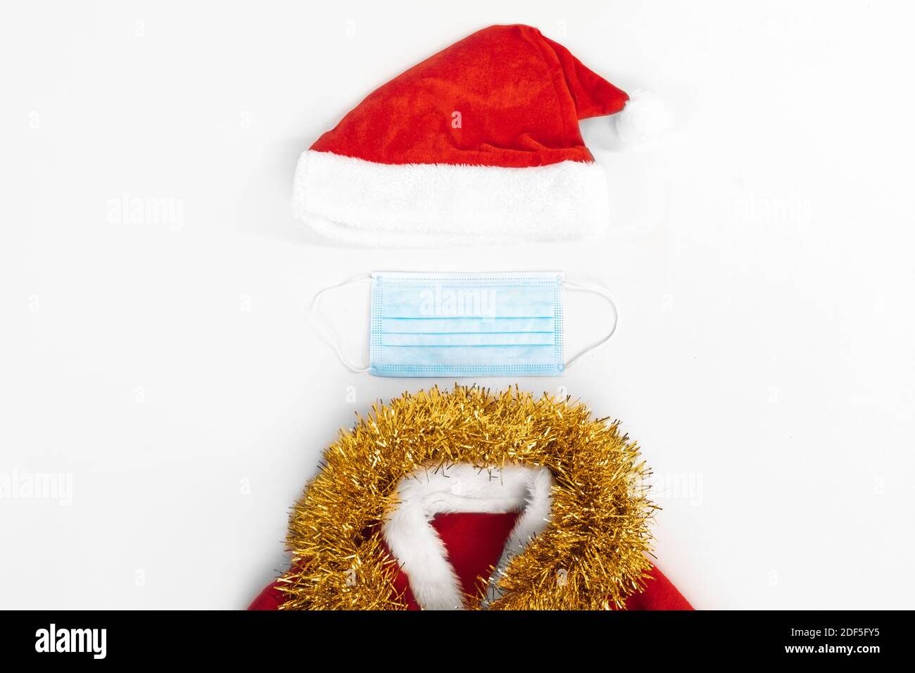 Christmas hat and santa claus costume with face mask on white ...