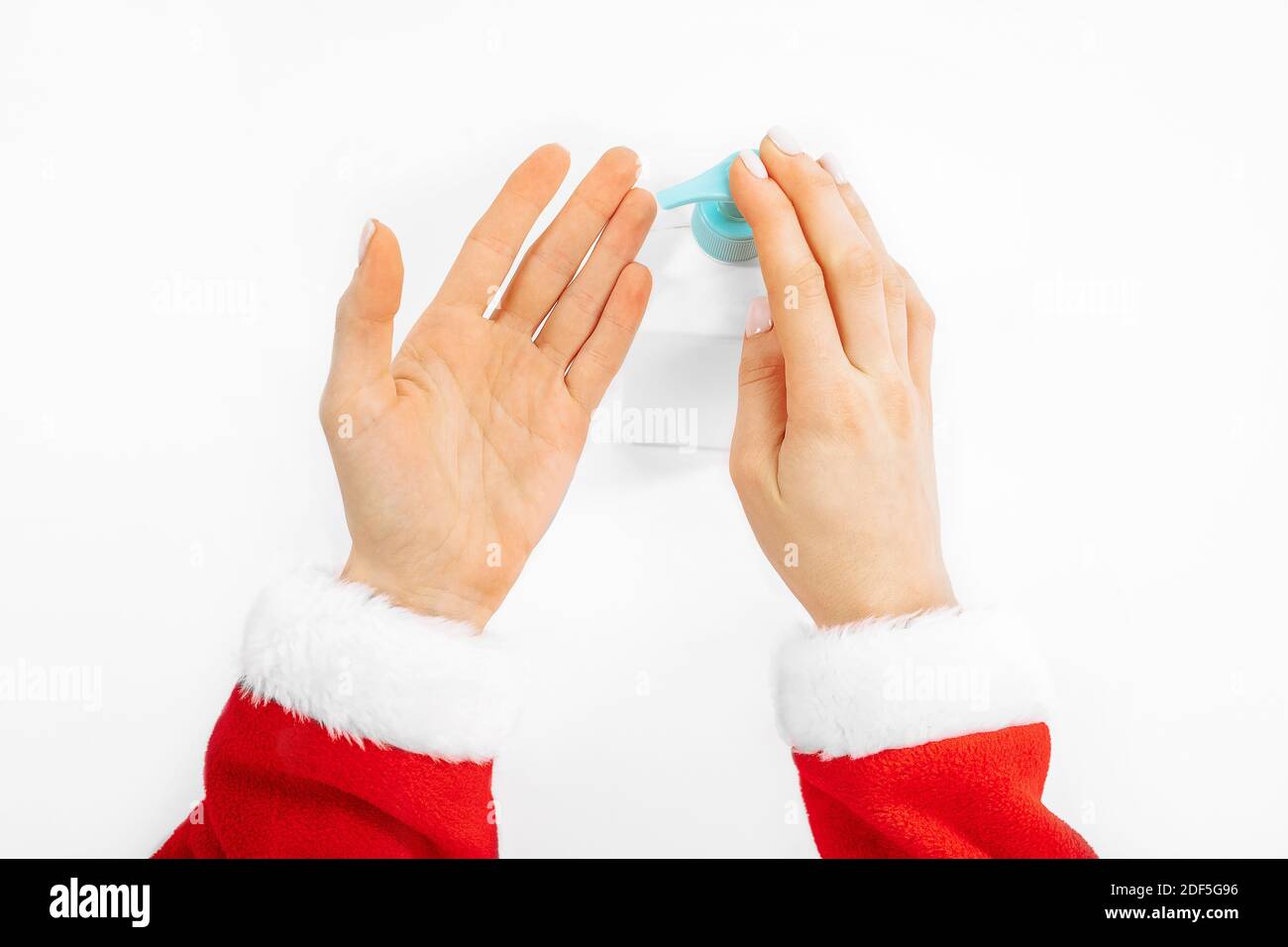 Covid-19 Santa Claus, hands of Santa Claus, applying disinfectant ...