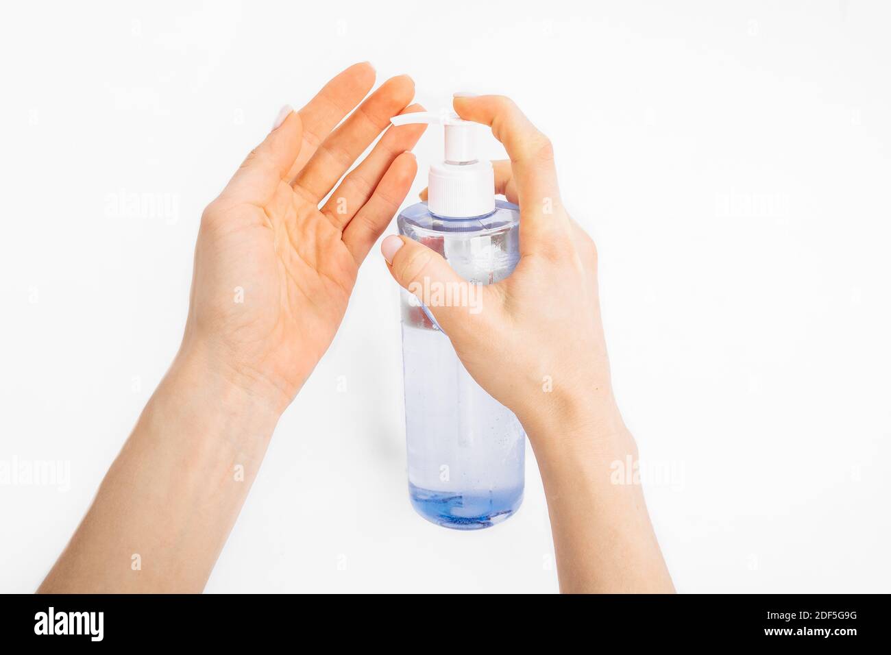 Disinfection of hands. Man applying antiseptic spray to his hands to ...