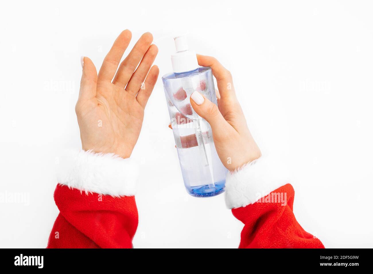 Covid-19 Santa Claus, hands of Santa Claus, applying disinfectant ...
