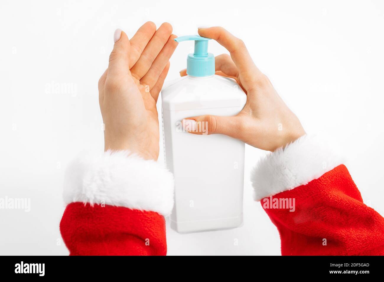 Covid-19 Santa Claus, hands of Santa Claus, applying disinfectant ...