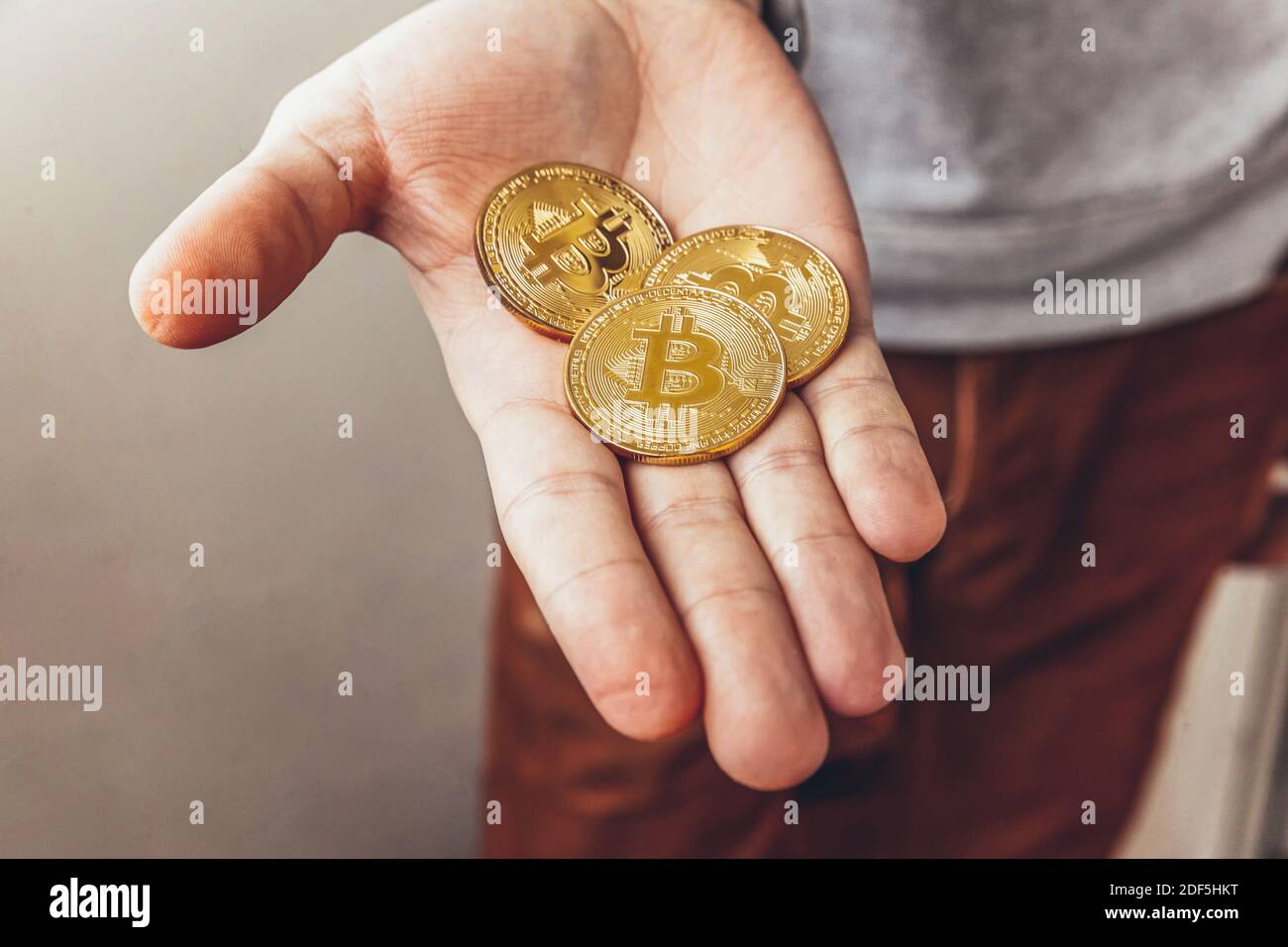 Man hand holding cryptocurrency golden bitcoin coin. Electronic virtual ...