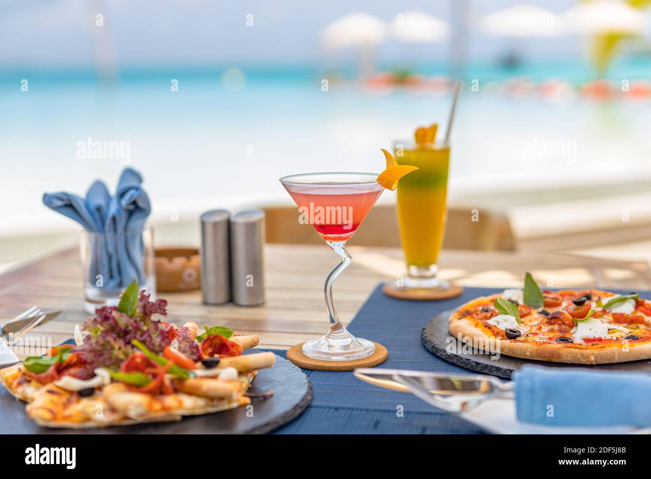 Luxury resort hotel poolside, outdoor restaurant on the beach, ocean ...