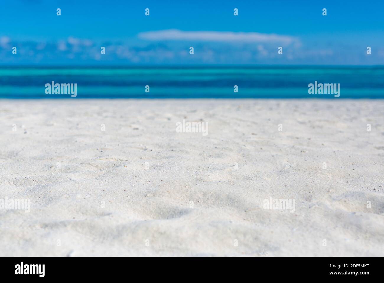 Sea sand sky concept. Closeup of sand on beach and blue summer sky ...