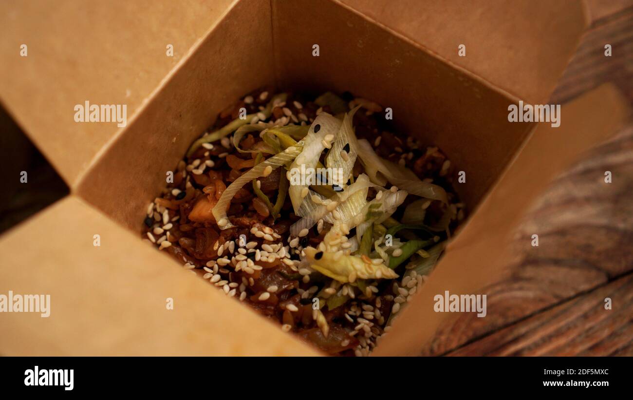 Box of stir-fried rice with vegetables and meat. Tasty mix. Chinese ...