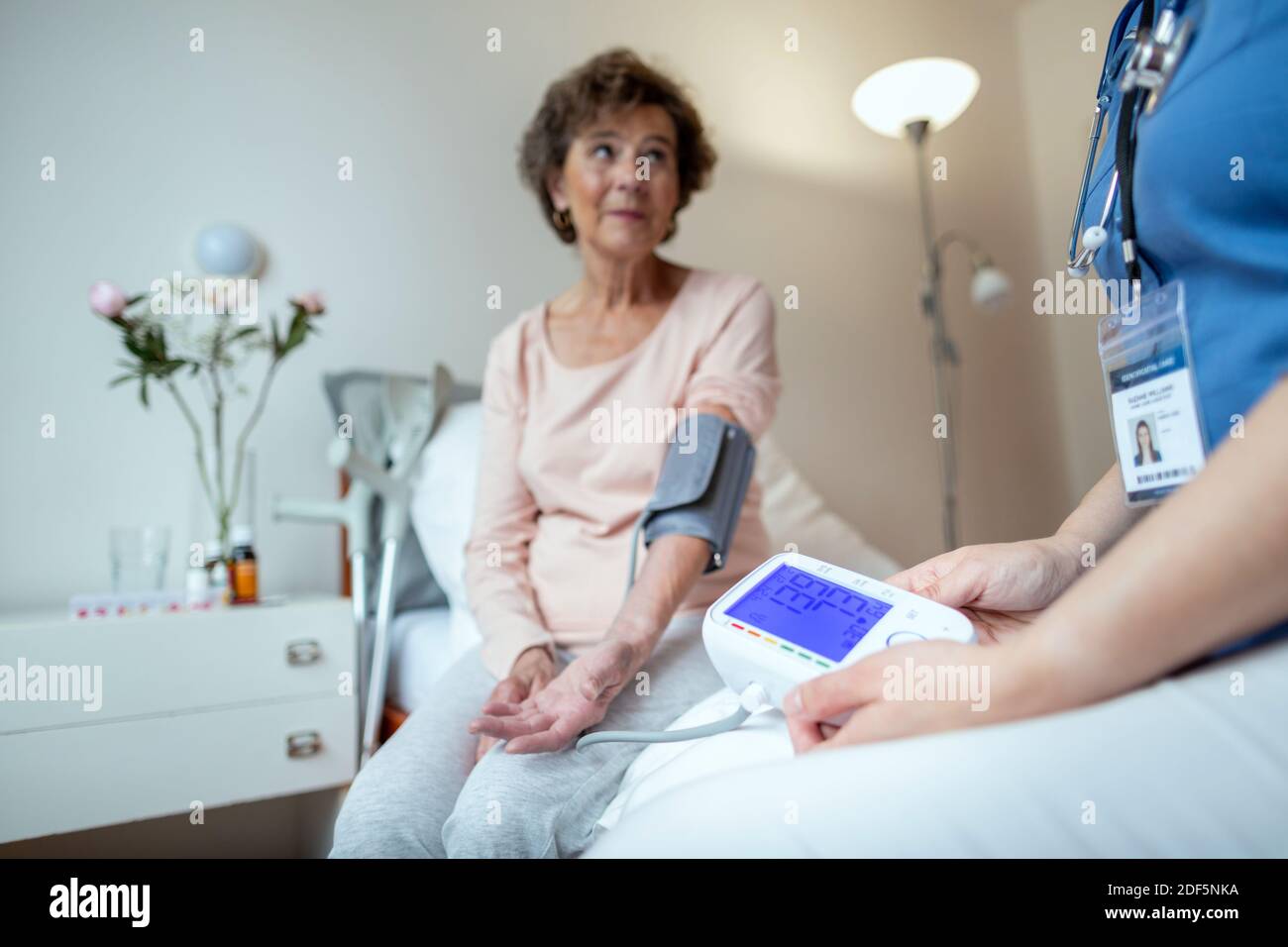 Home Nurse Checking Blood Pressure of Female Senior Patient With Focus ...