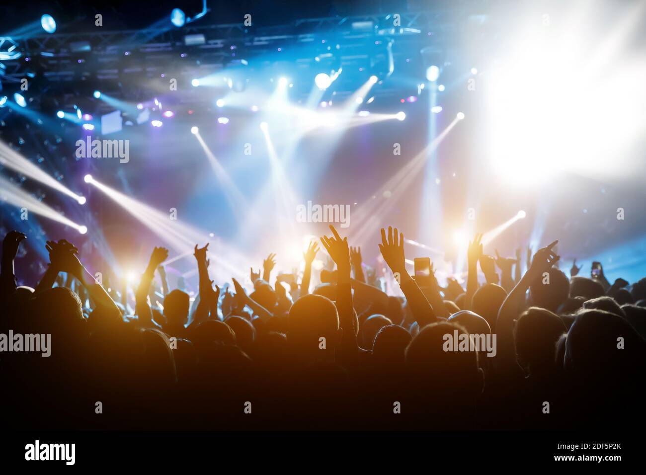 Performace of a popular group. Crowd is dancing and having fun. Hands ...