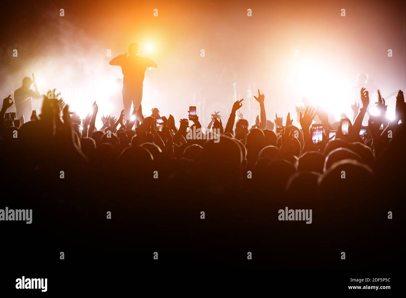Rock concert. Leader on the stage. Silhouette of the crowd in front of ...