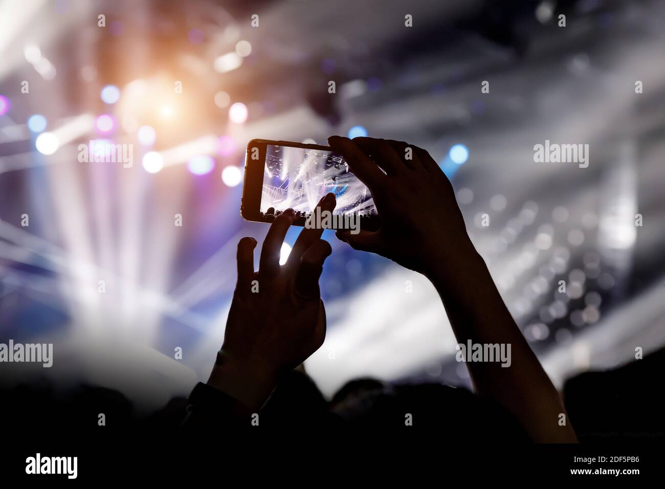 Shooting on mobile phone. Concert on stage Stock Photo - Alamy