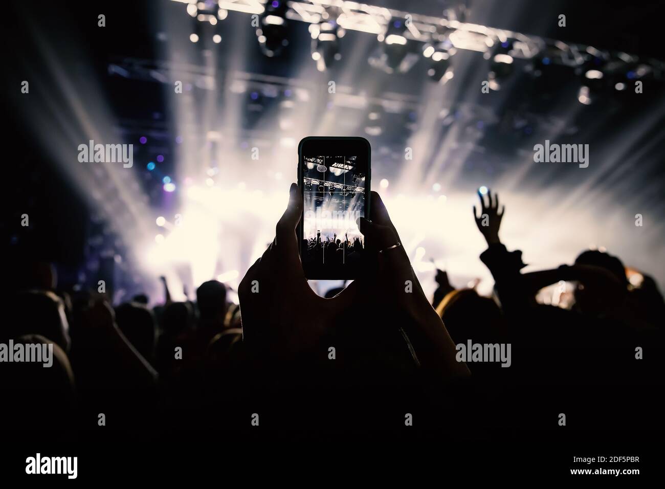 Social media photo to mobile phone. Concert light performance Stock ...
