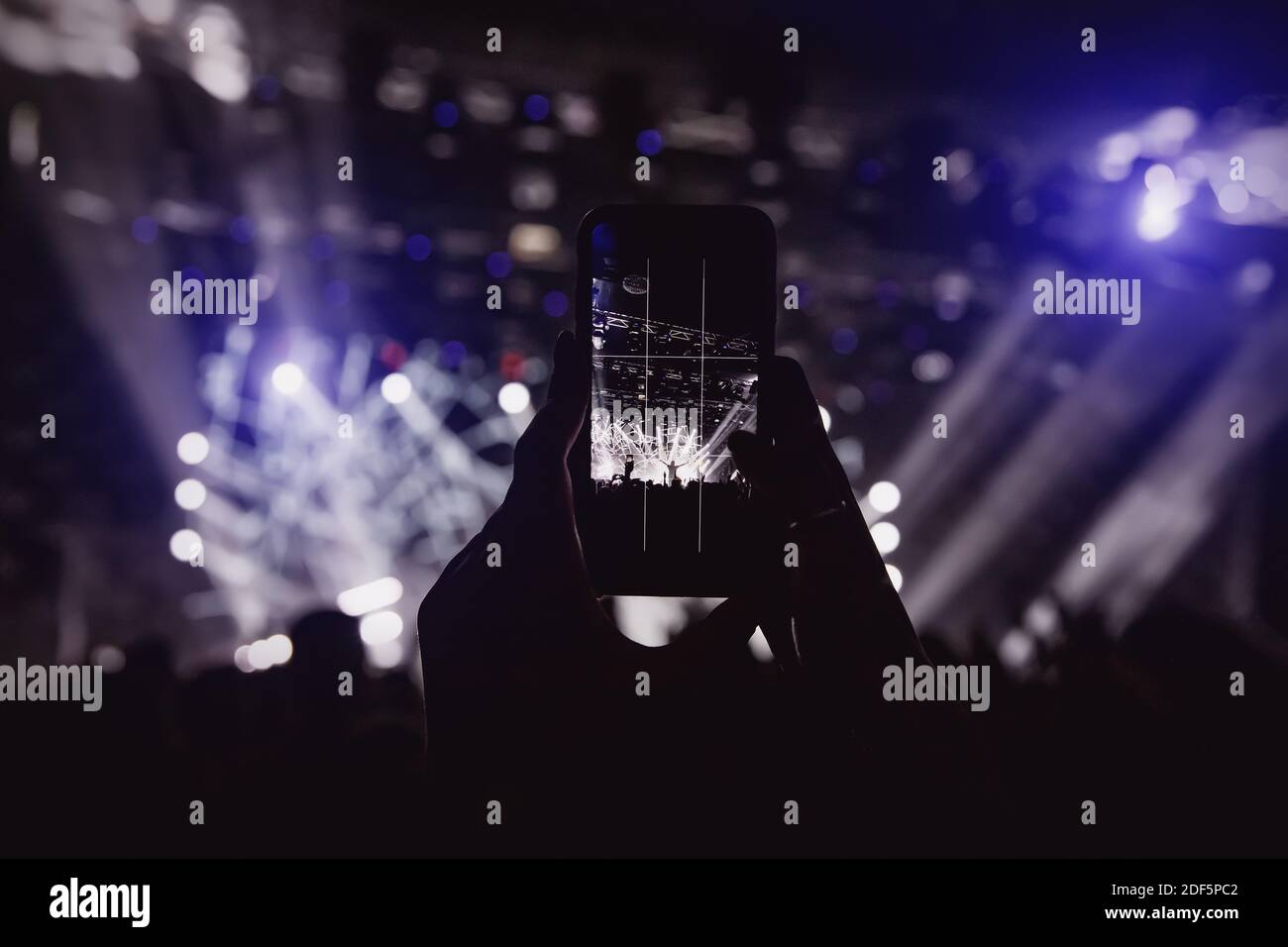 Social media photo to mobile phone. Concert light performance Stock ...