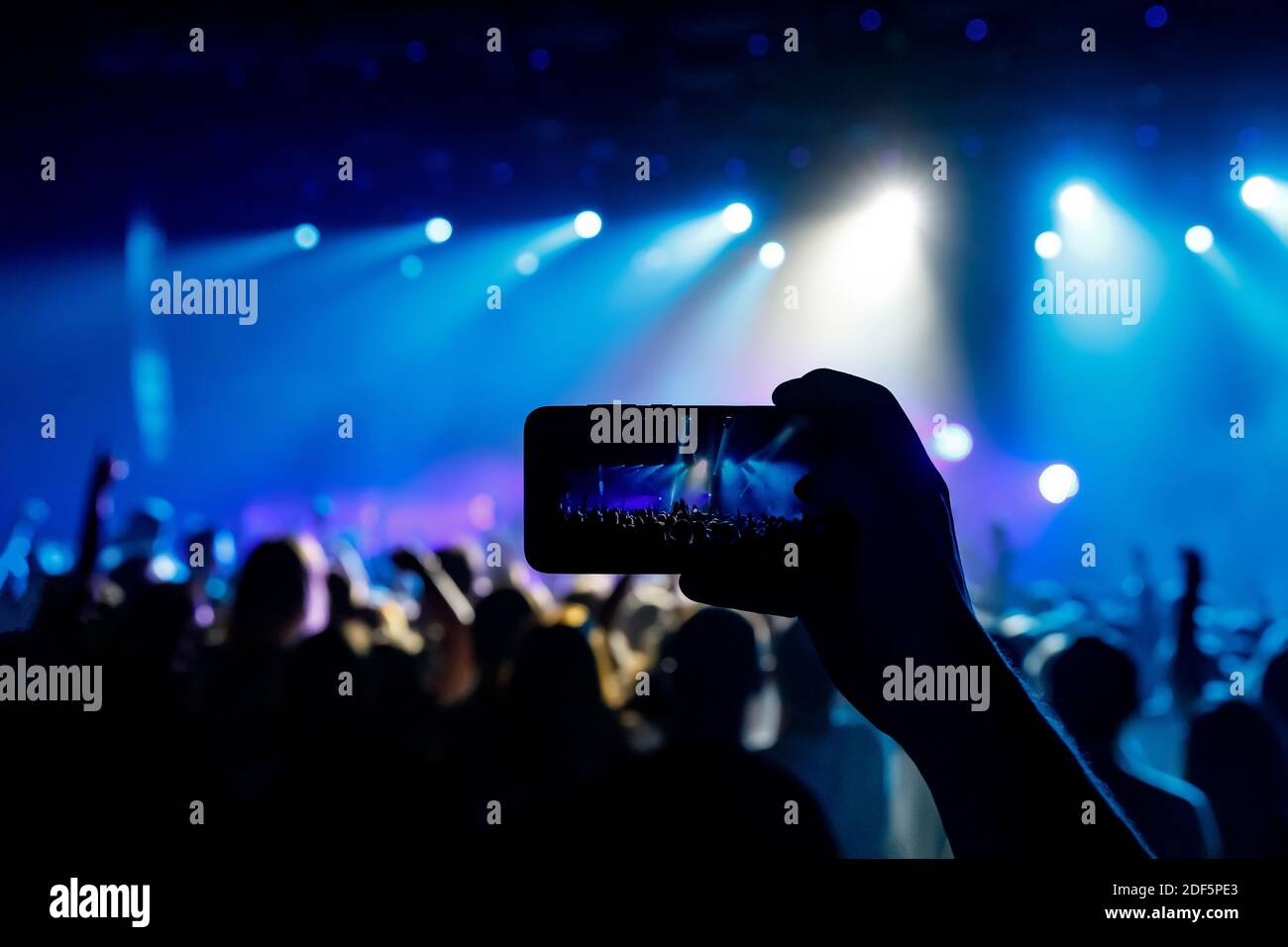 Social media photo to mobile phone. Concert light performance Stock ...