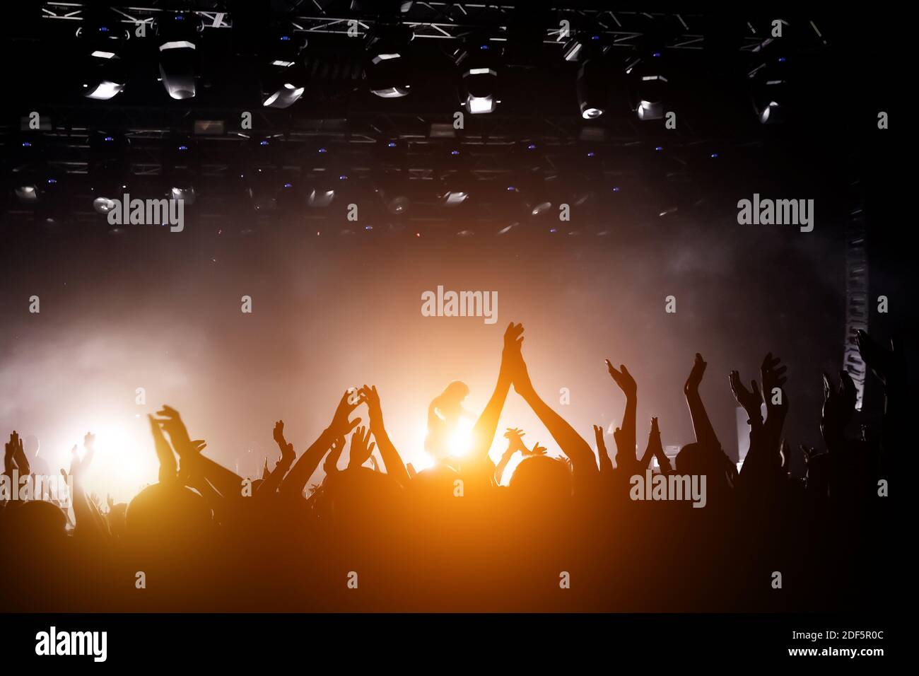 Performace of a popular group. Crowd is dancing and having fun. Hands ...
