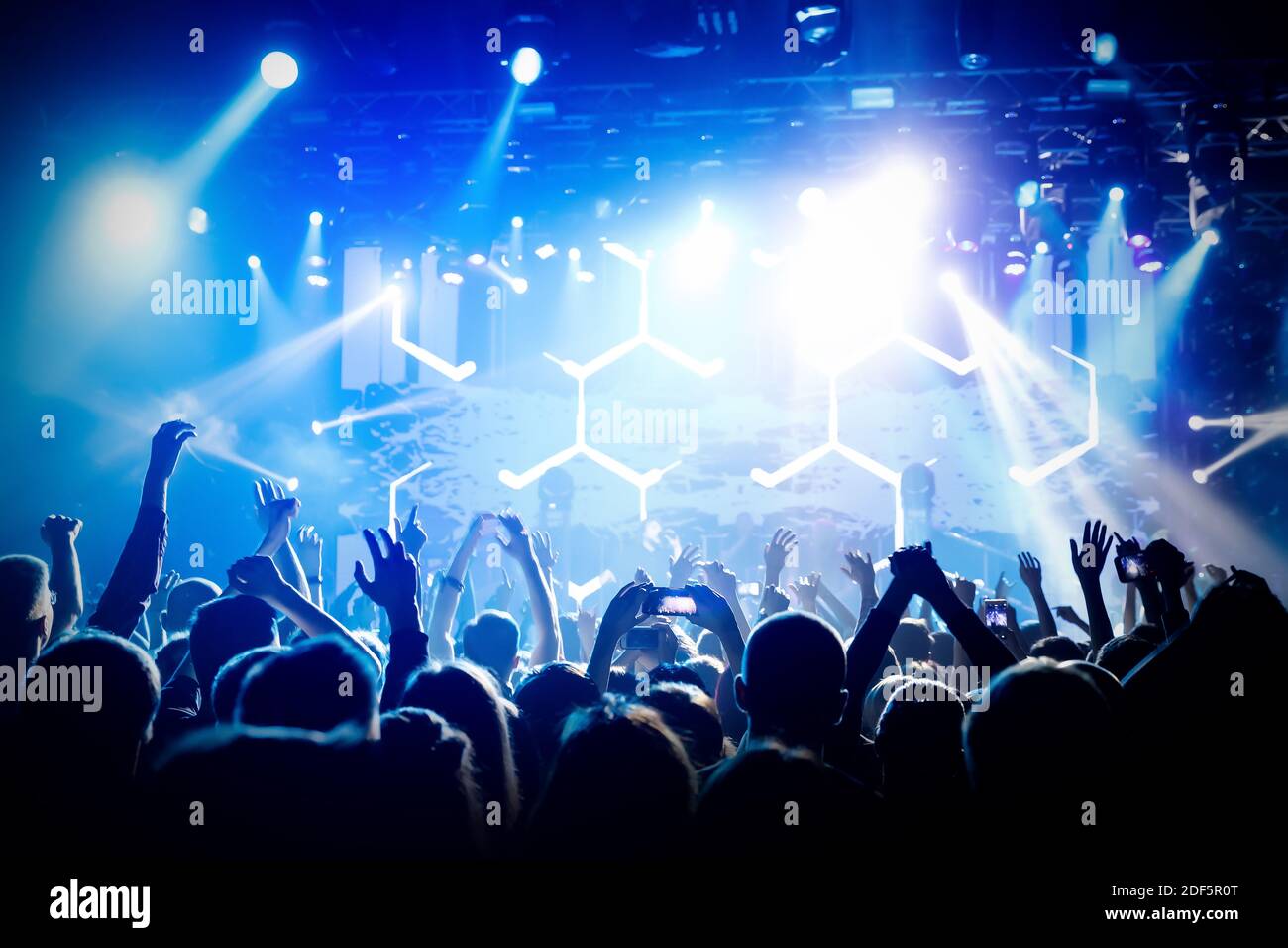 Performace of a popular group. Crowd is dancing and having fun. Hands ...