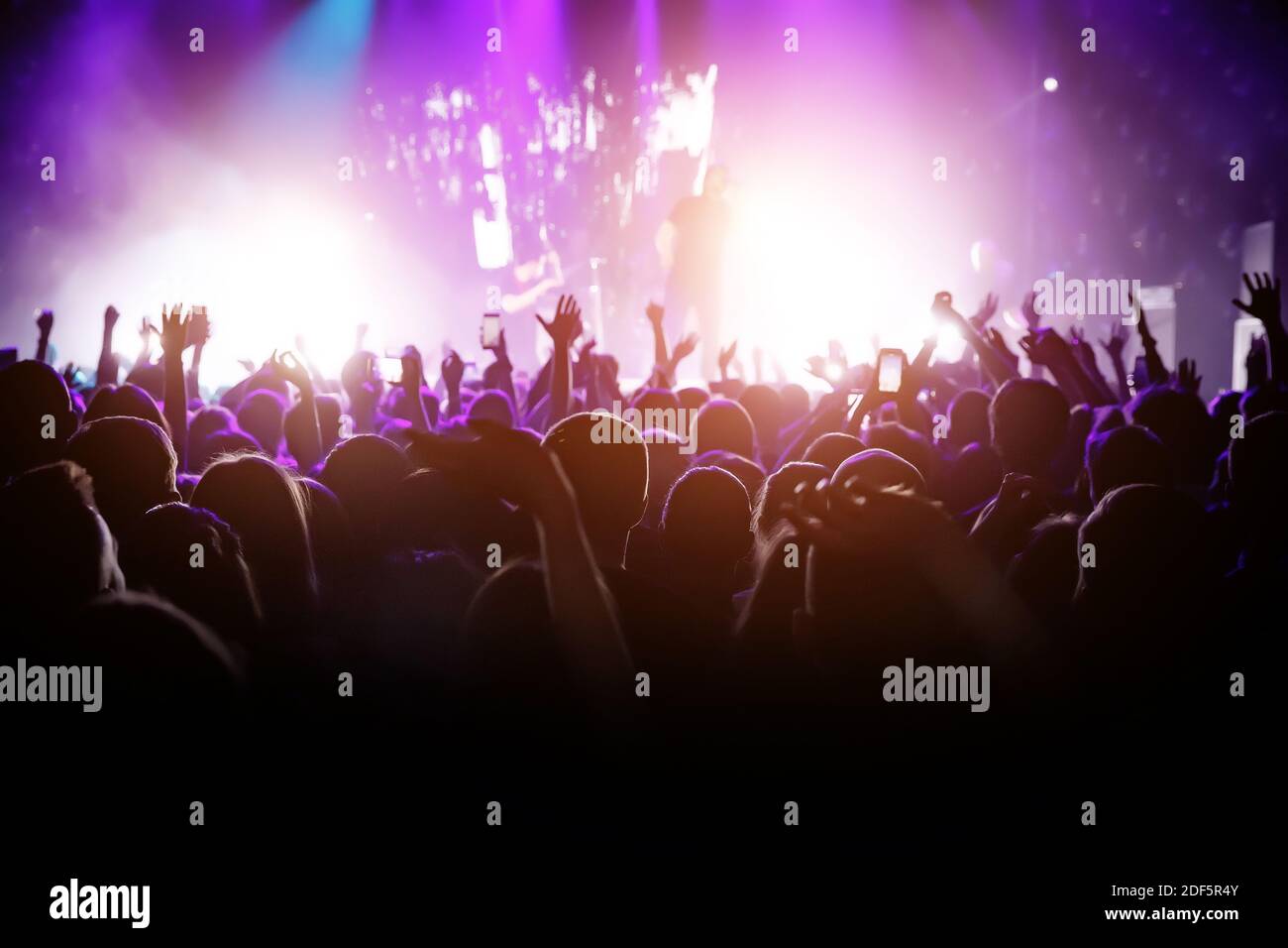A lot of people on music show. Light from stage Stock Photo - Alamy