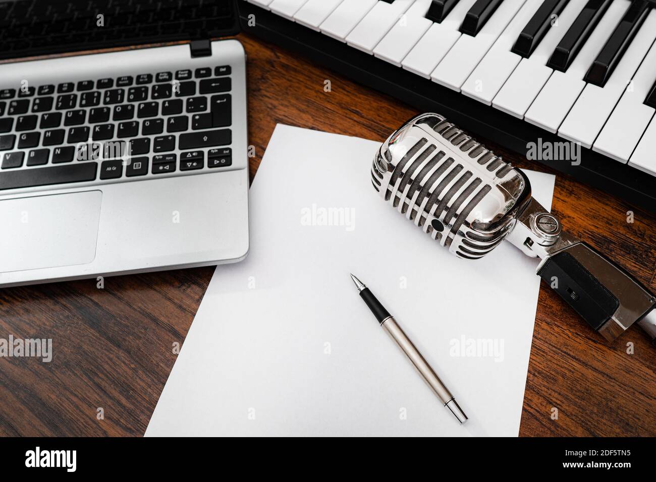 Music studio equipment and white paper with pen. Songwriting concept ...