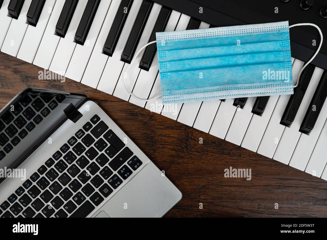 Piano and medical mask in music studio. Covid-19 restrictions concept ...